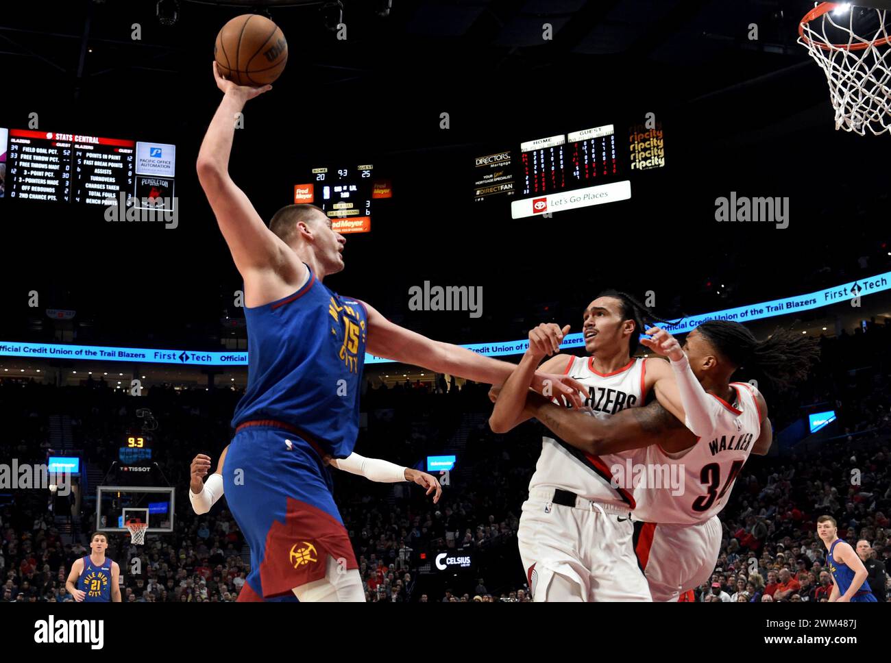 Denver Nuggets center Nikola Jokic, left, holds off Portland Trail ...