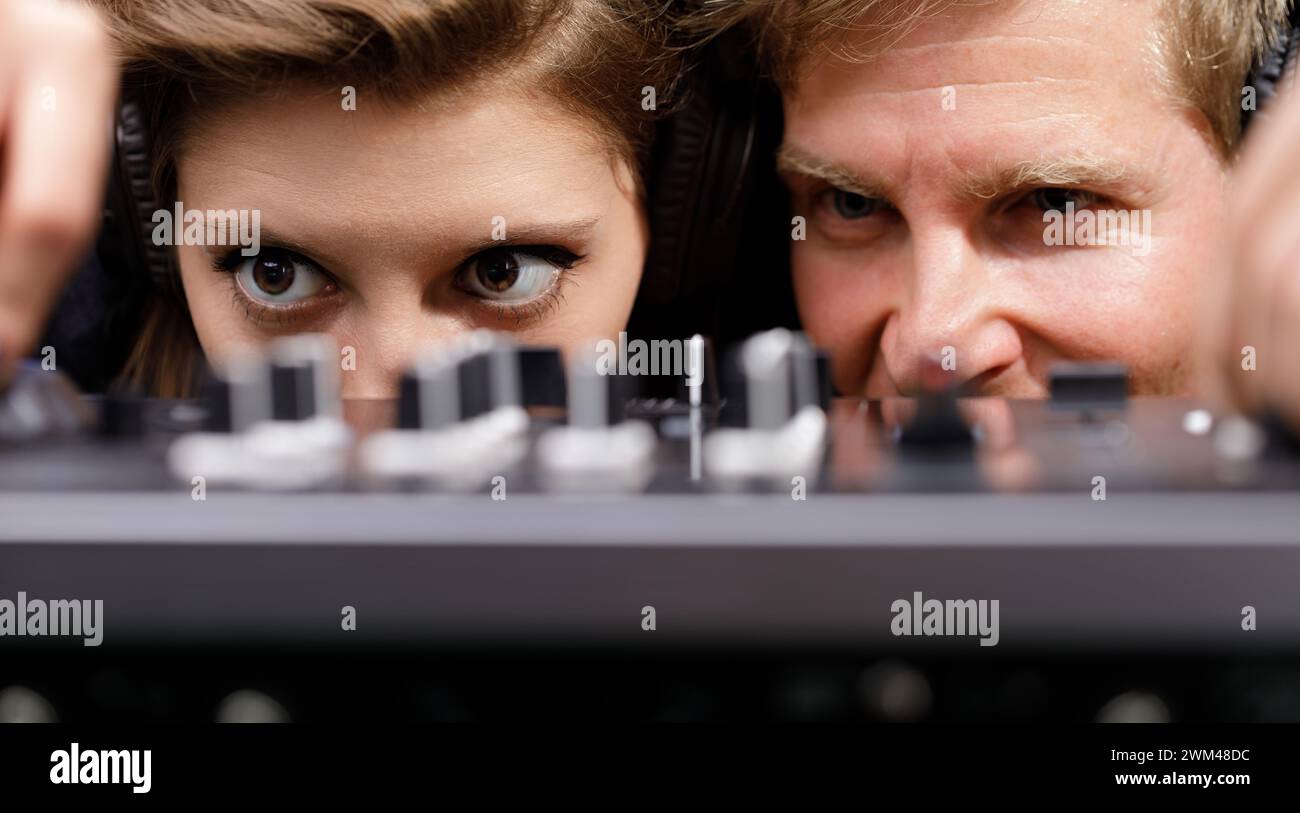close-up of DJs in action, with their eyes locked on the mixer ...