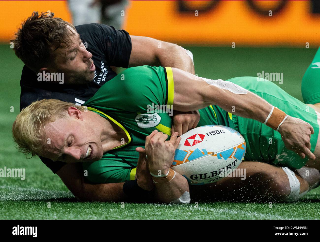 Ireland's Connor O'Sullivan scores a try as New Zealand's Tim Mikkelson ...