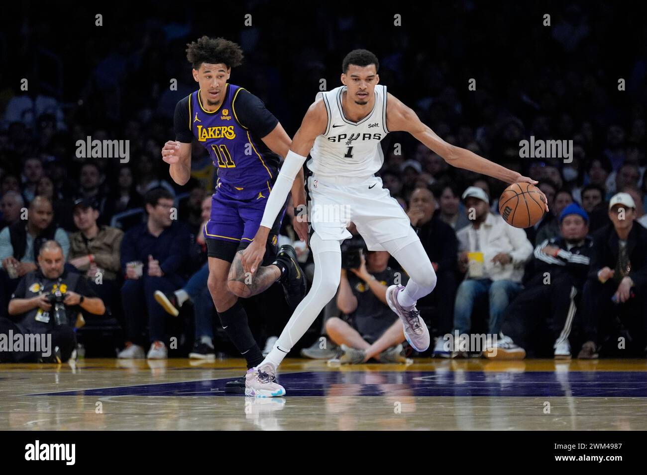 San Antonio Spurs center Victor Wembanyama (1) dribbles past Los Angeles Lakers center Jaxson ...