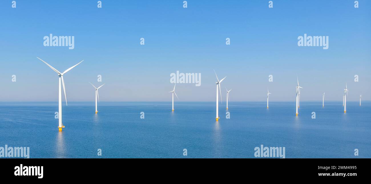A wind farm with rows of wind turbines in the middle of the ocean ...
