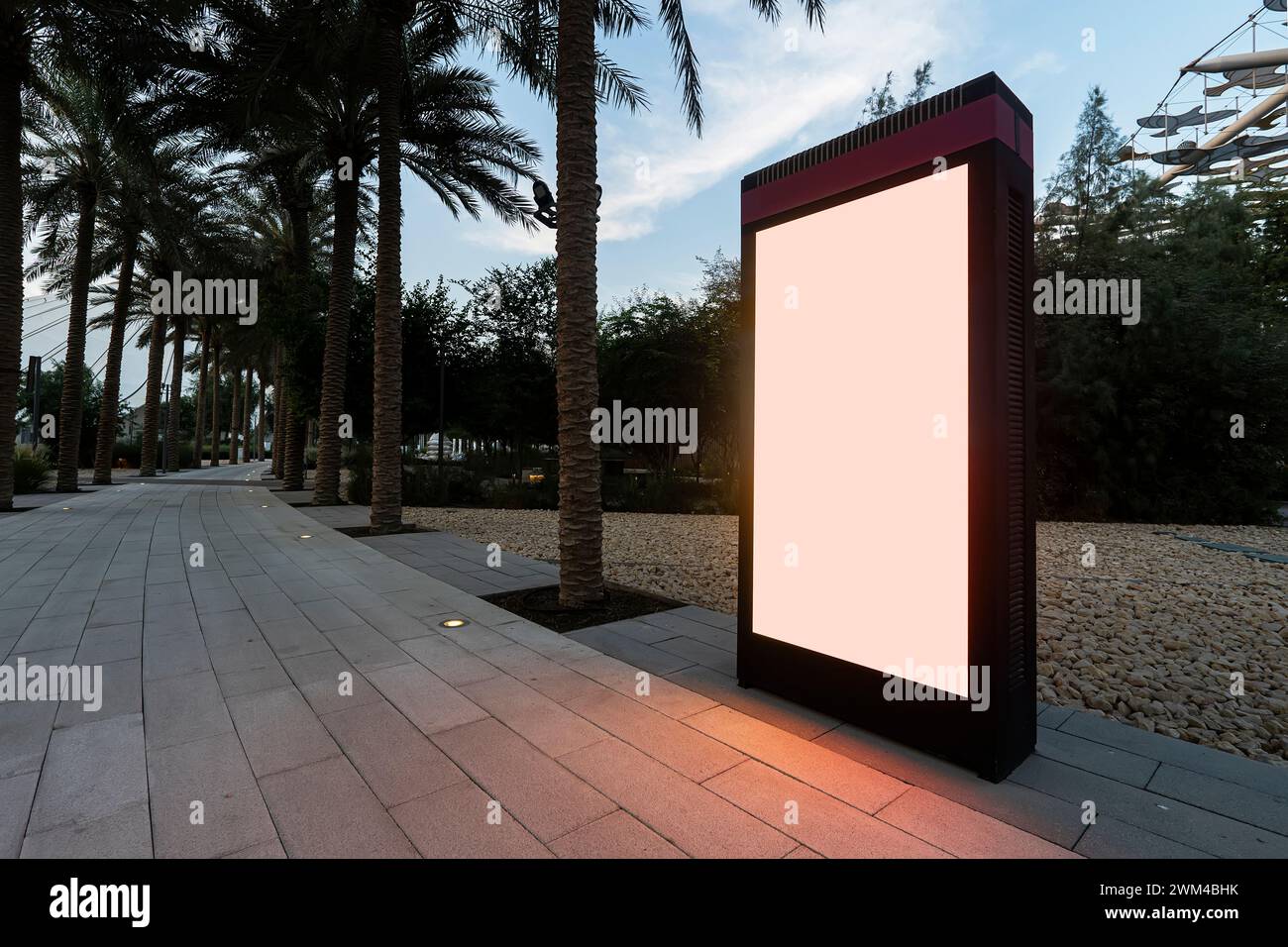 An electronic scoreboard with an empty white screen on a city street ...