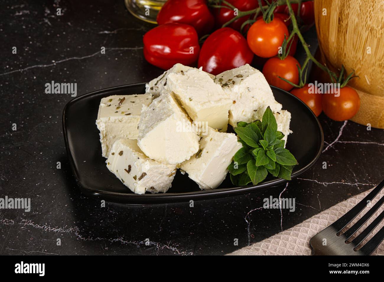 Greek traditional Feta cheese cubes with herbs and spices Stock Photo ...