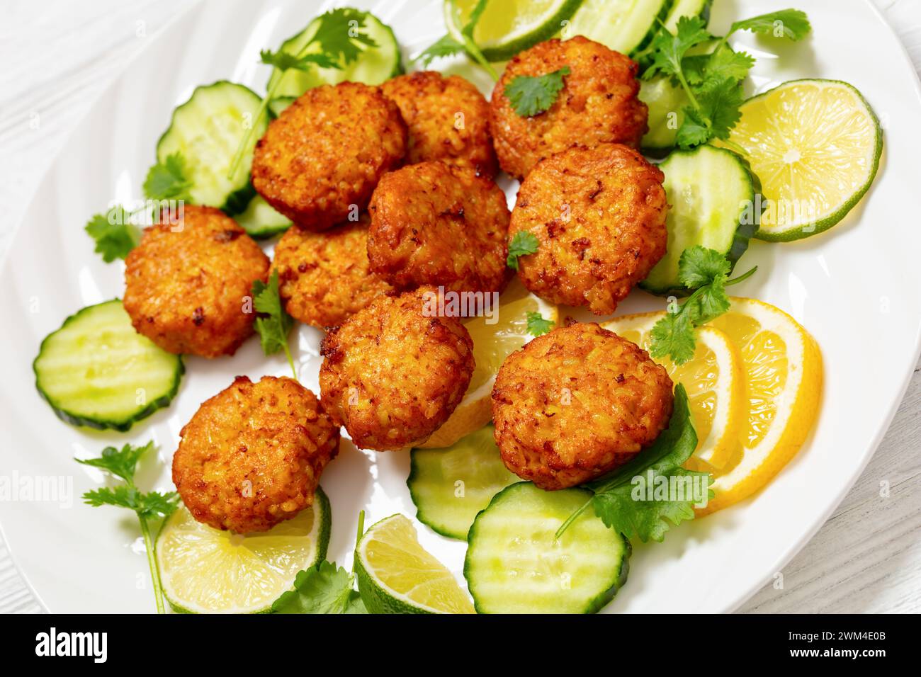 fried rice patties, rice tikki, indian style on white plate served with ...