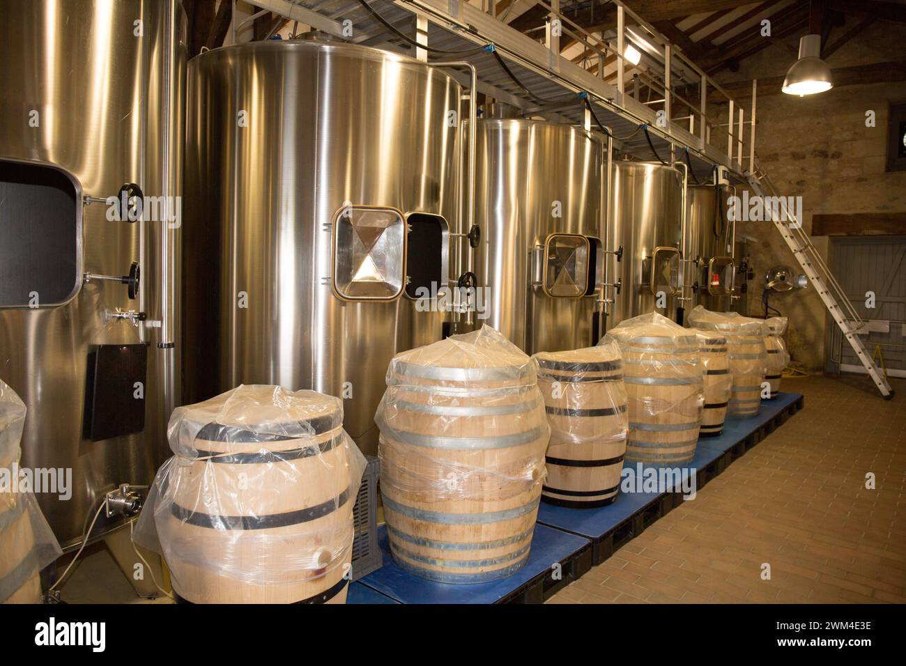 Modern aluminum barrels where grape juice is aged into wine, France ...