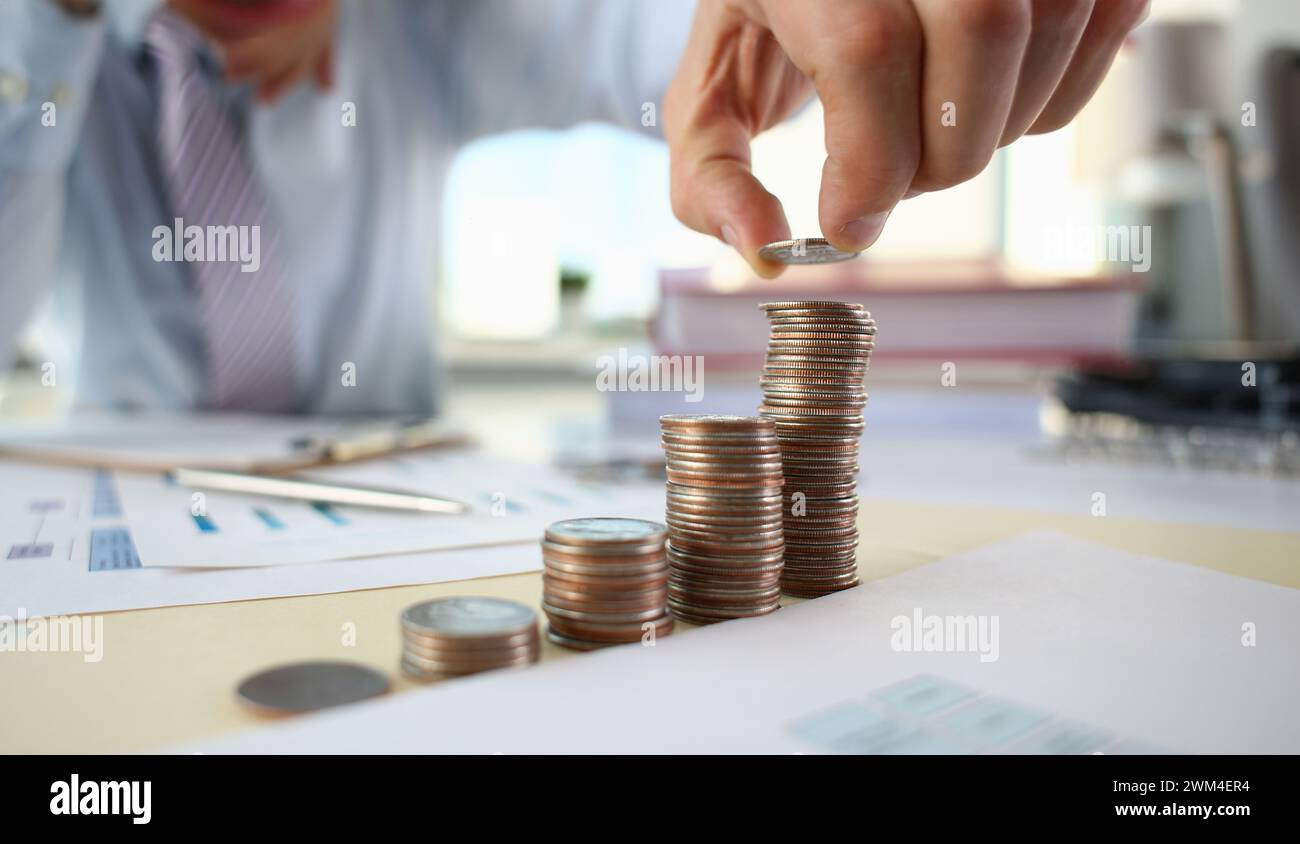 Hand businessman putting pin money Stock Photo - Alamy