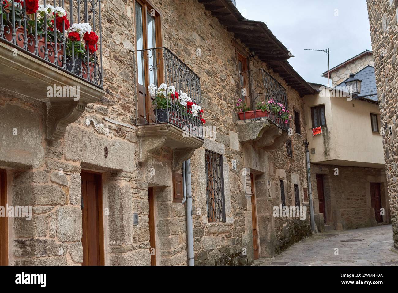 Old village with picturesque stone buildings and flowers in Puebla de ...
