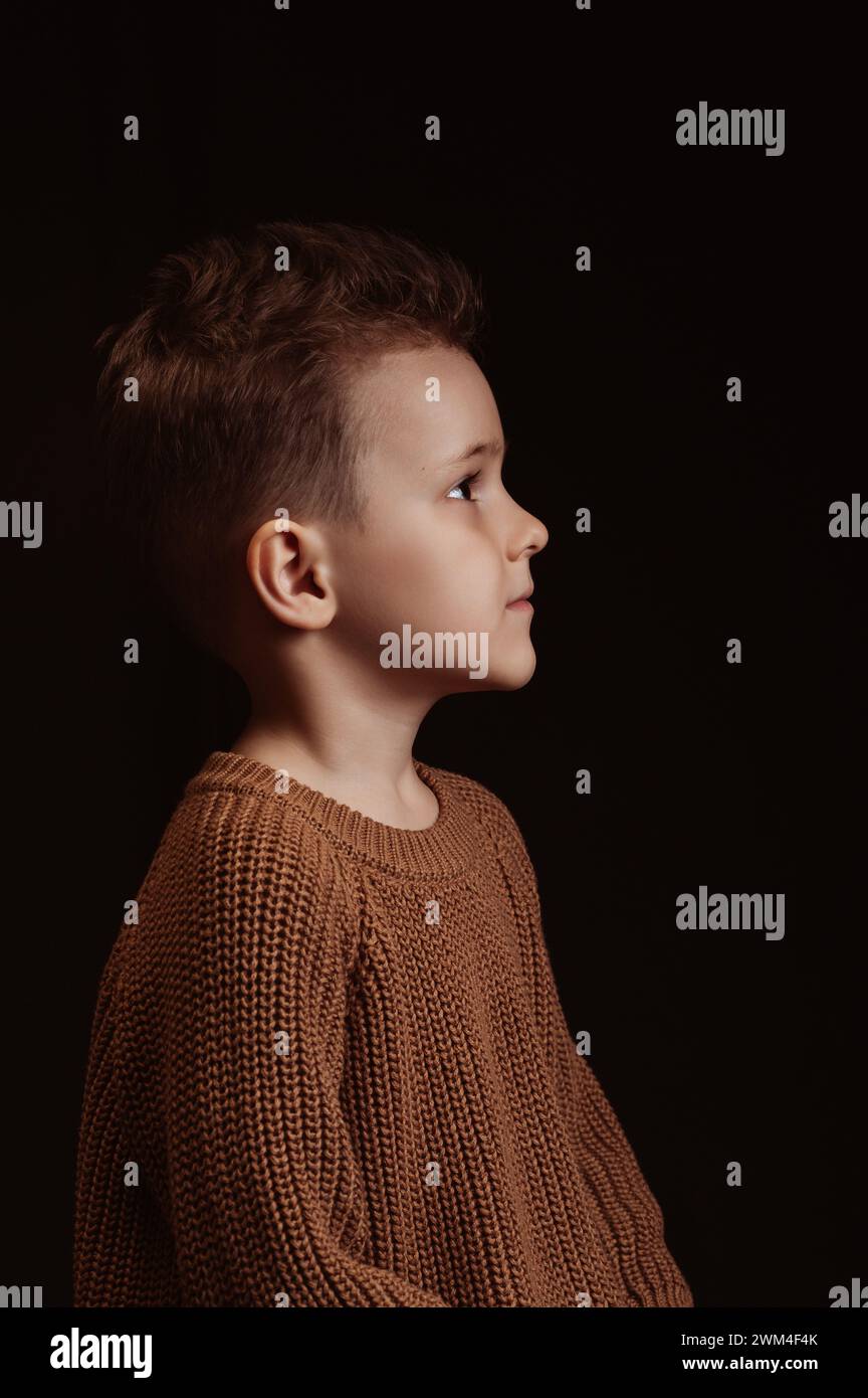 Profile portrait of a serious sad white Caucasian child preschooler kid ...