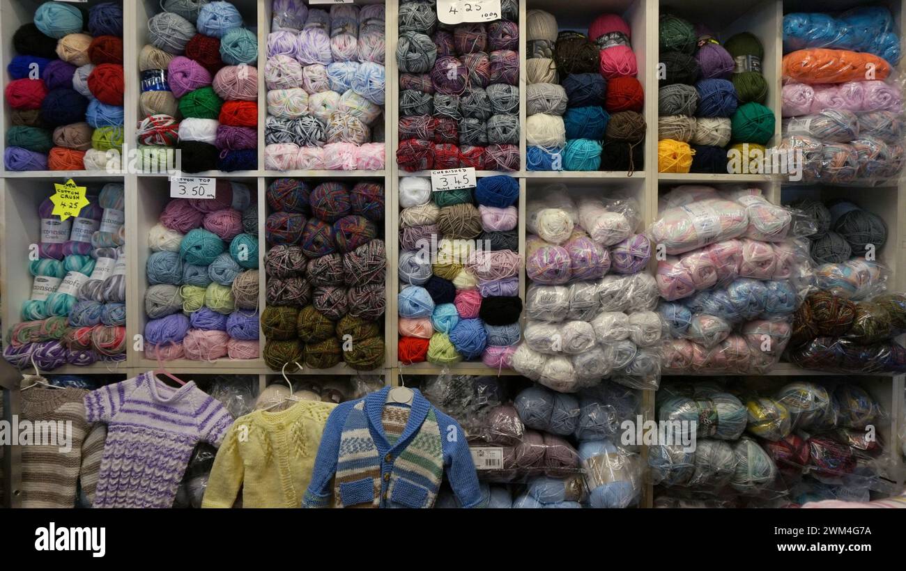 Old fashioned wool shop interior. Photographs show wool racked on ...