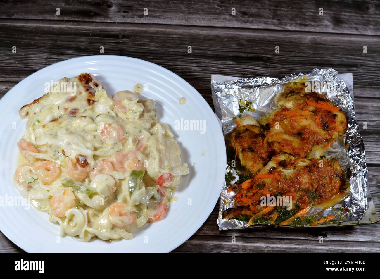 Baked creamy seafood baked mix of shrimps, squid calamari, fish fillet ...