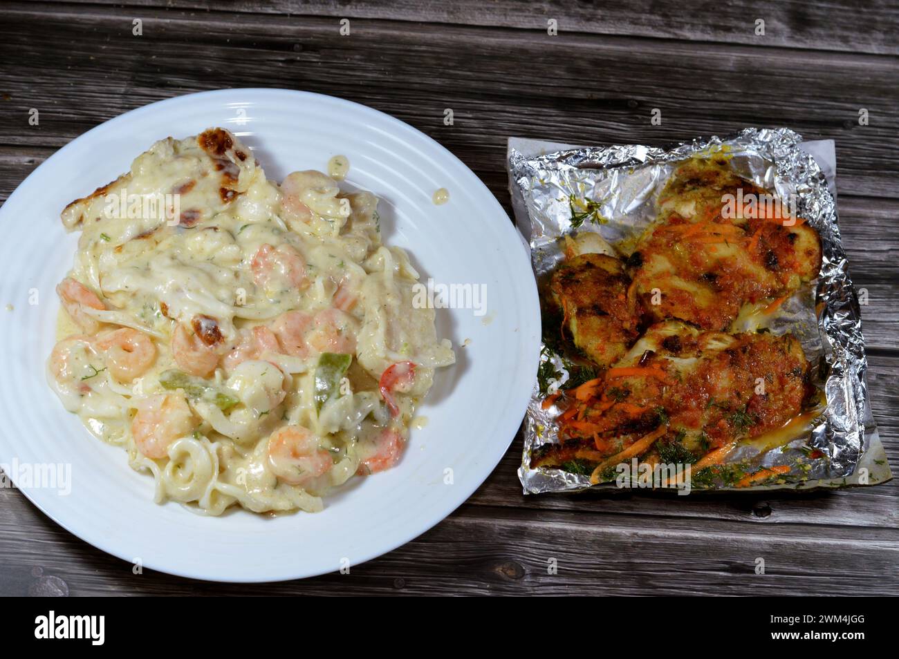 Baked creamy seafood baked mix of shrimps, squid calamari, fish fillet ...