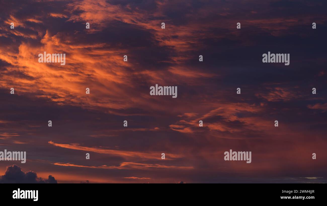 Dramatic sunset with vibrant clouds lit by a sun, nature background ...