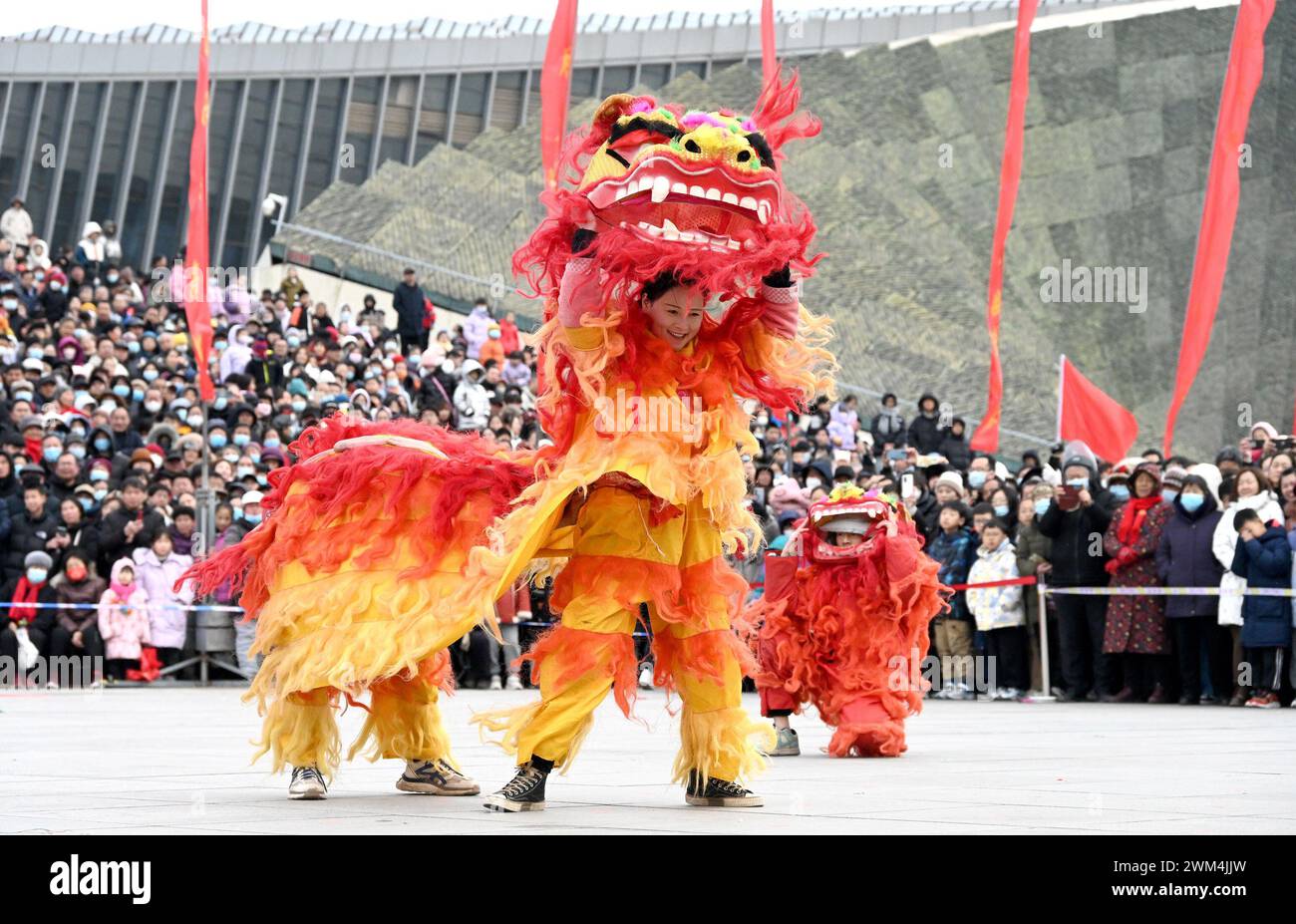Handan, China. 24th Feb, 2024. Folk artists are performing a lion dance ...