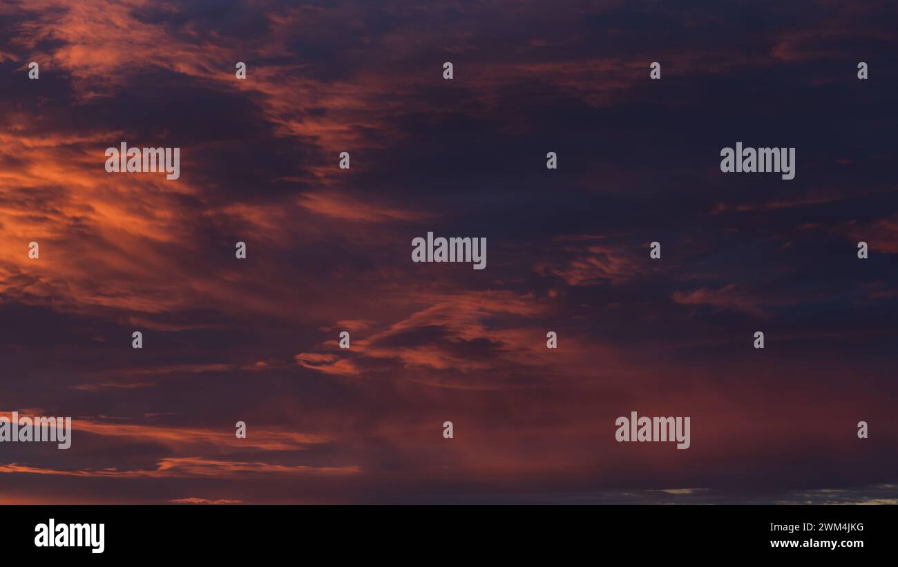 Dramatic sunset with vibrant clouds lit by a sun, nature background ...