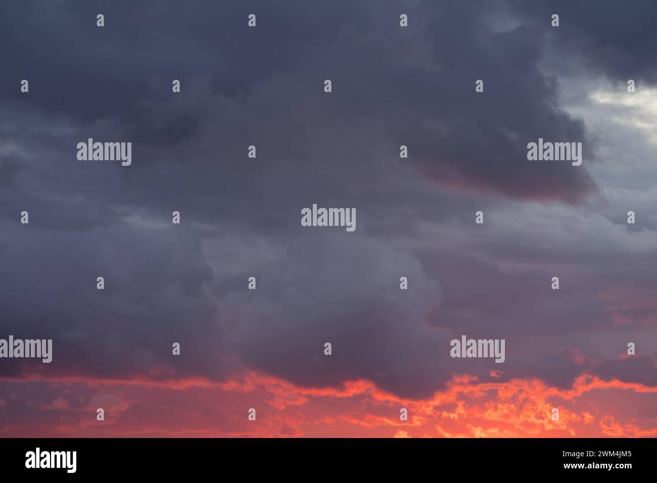 Dramatic sunset with vibrant clouds lit by a sun, nature background ...