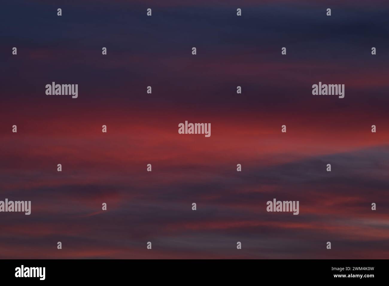 Dramatic sunset with vibrant clouds lit by a sun, nature background ...
