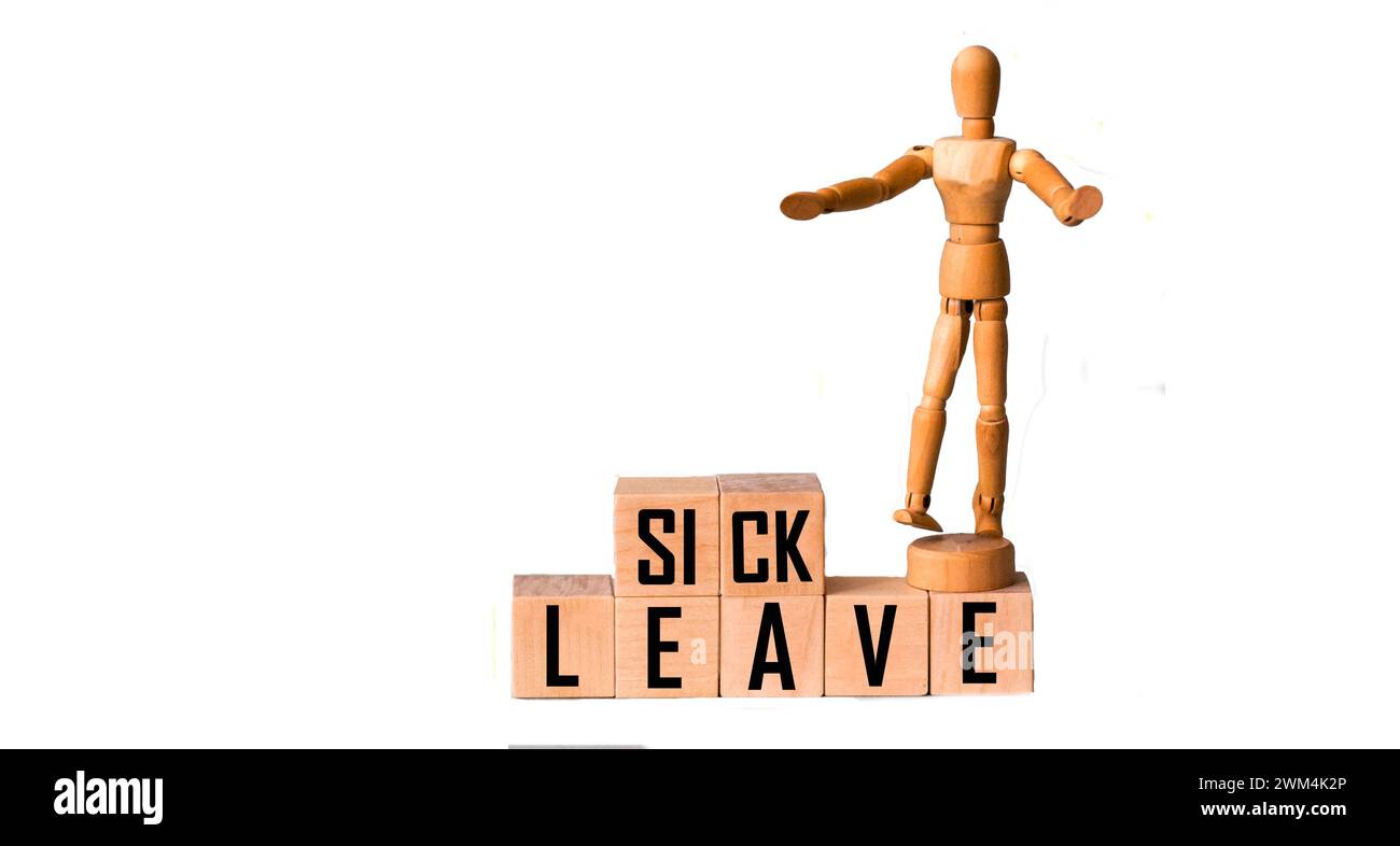 Sick note on a note on wooden blocks and a white background with a ...