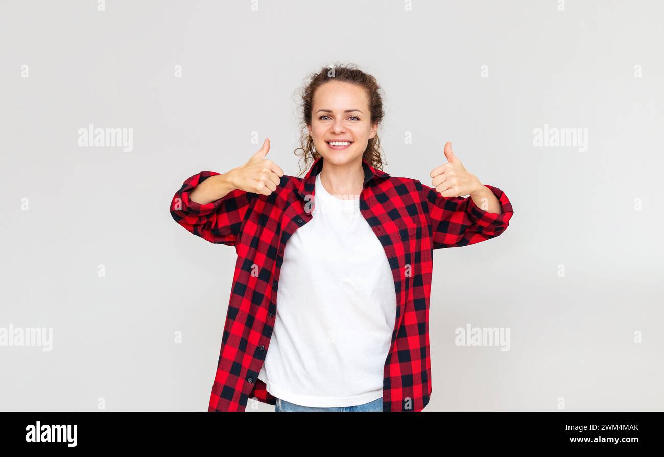 Happy confident young adult woman showing thumbs up and smiling in ...