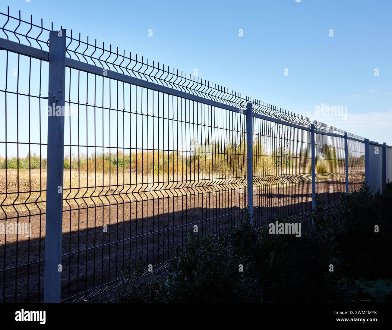 Metal wire fence to protect the territory. Painted wire mesh grille ...