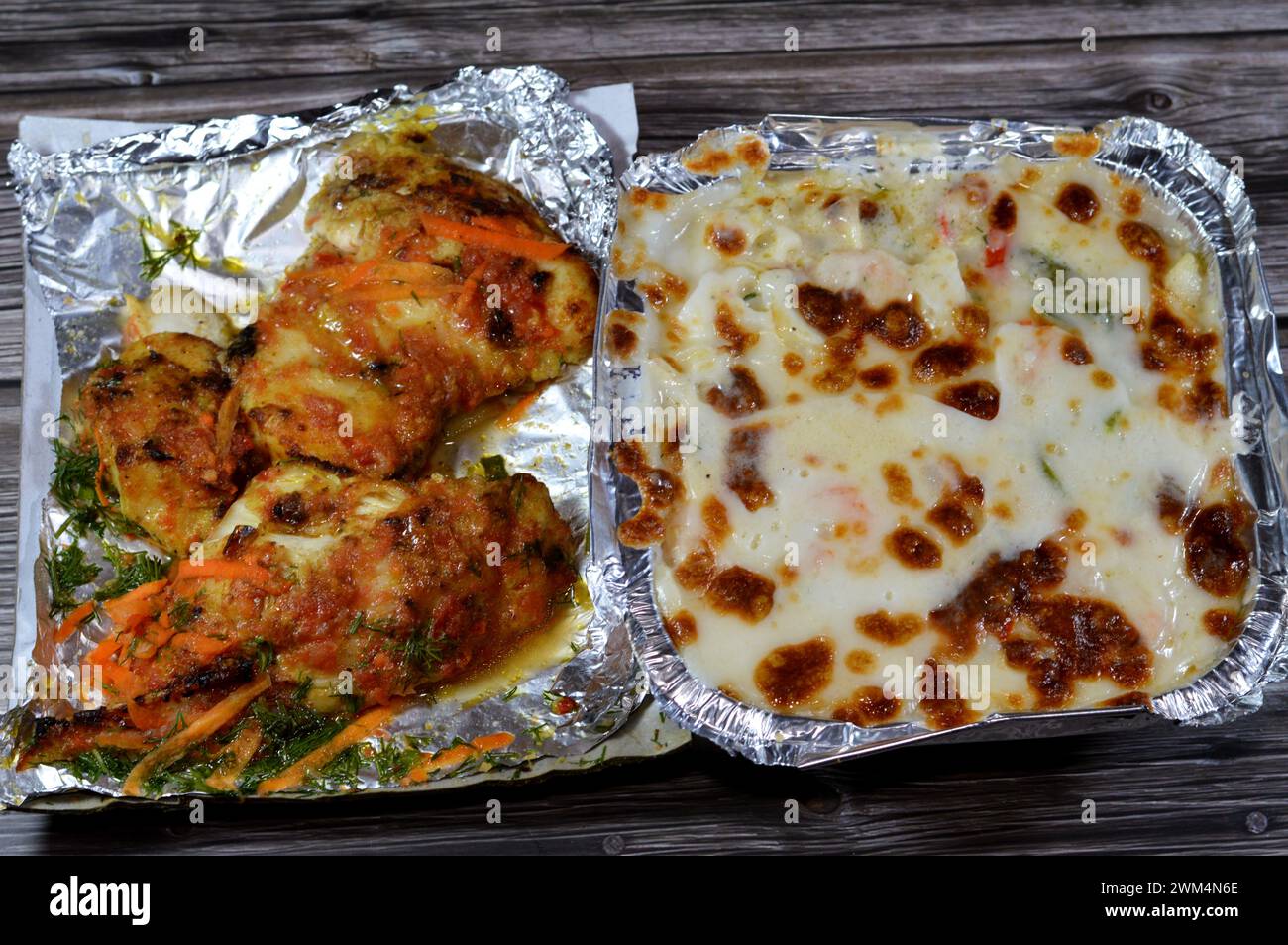 Baked creamy seafood baked mix of shrimps, squid calamari, fish fillet ...