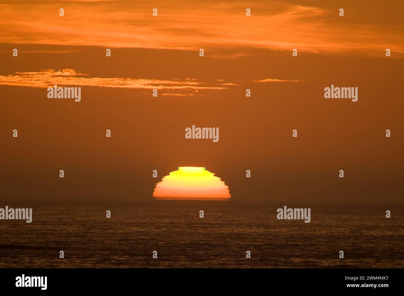Sunsetting green flash with clouds from the eastern horizon as seen ...