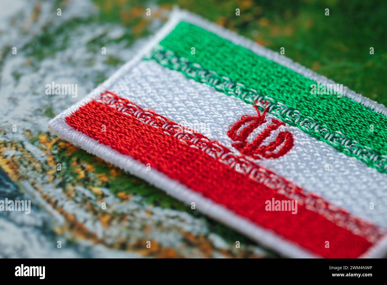 Flag of Iran, patch and symbol of the country on the background of the globe, Close up ...