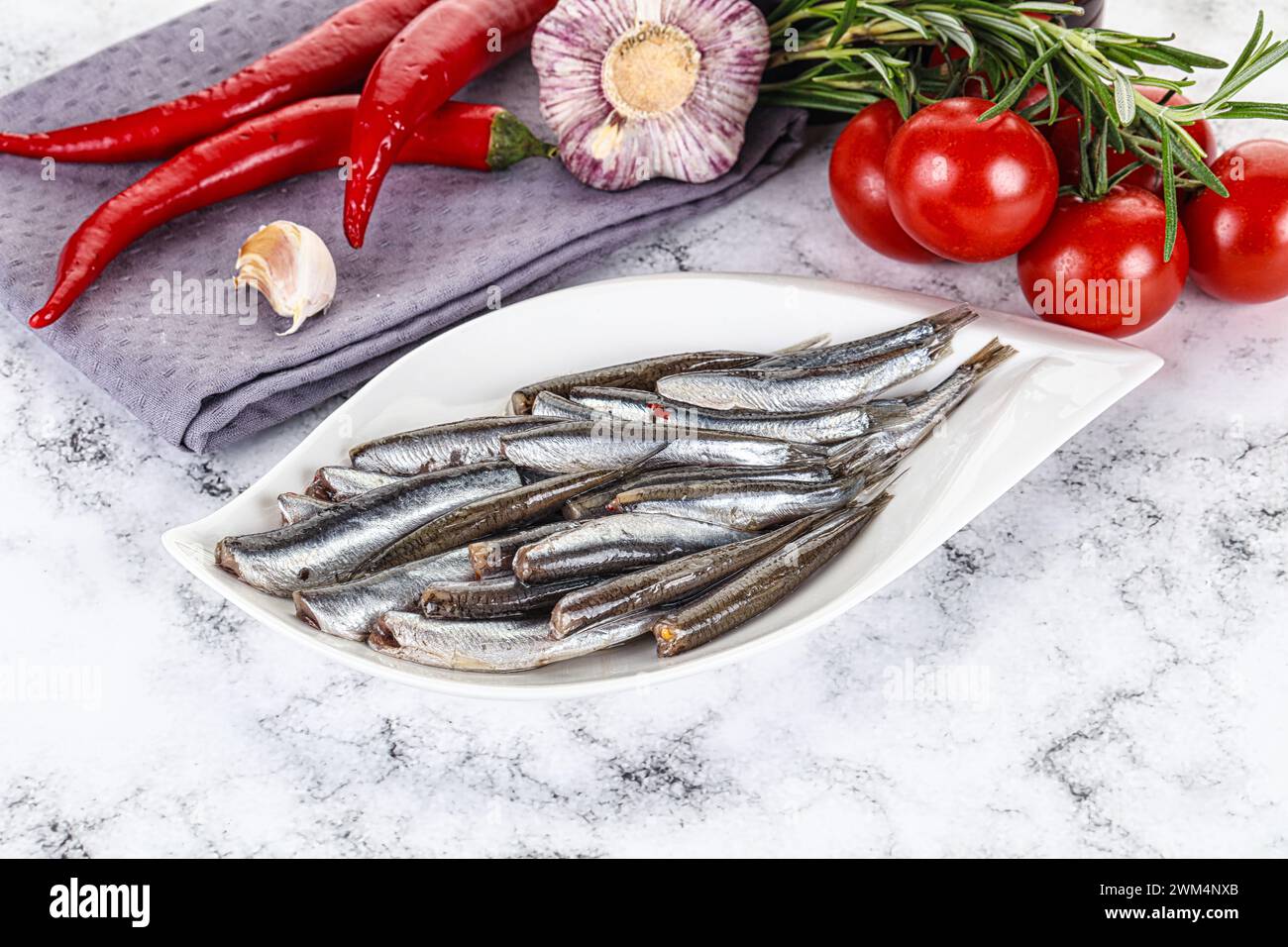 Pickled anchovy fish in the plate Stock Photo - Alamy