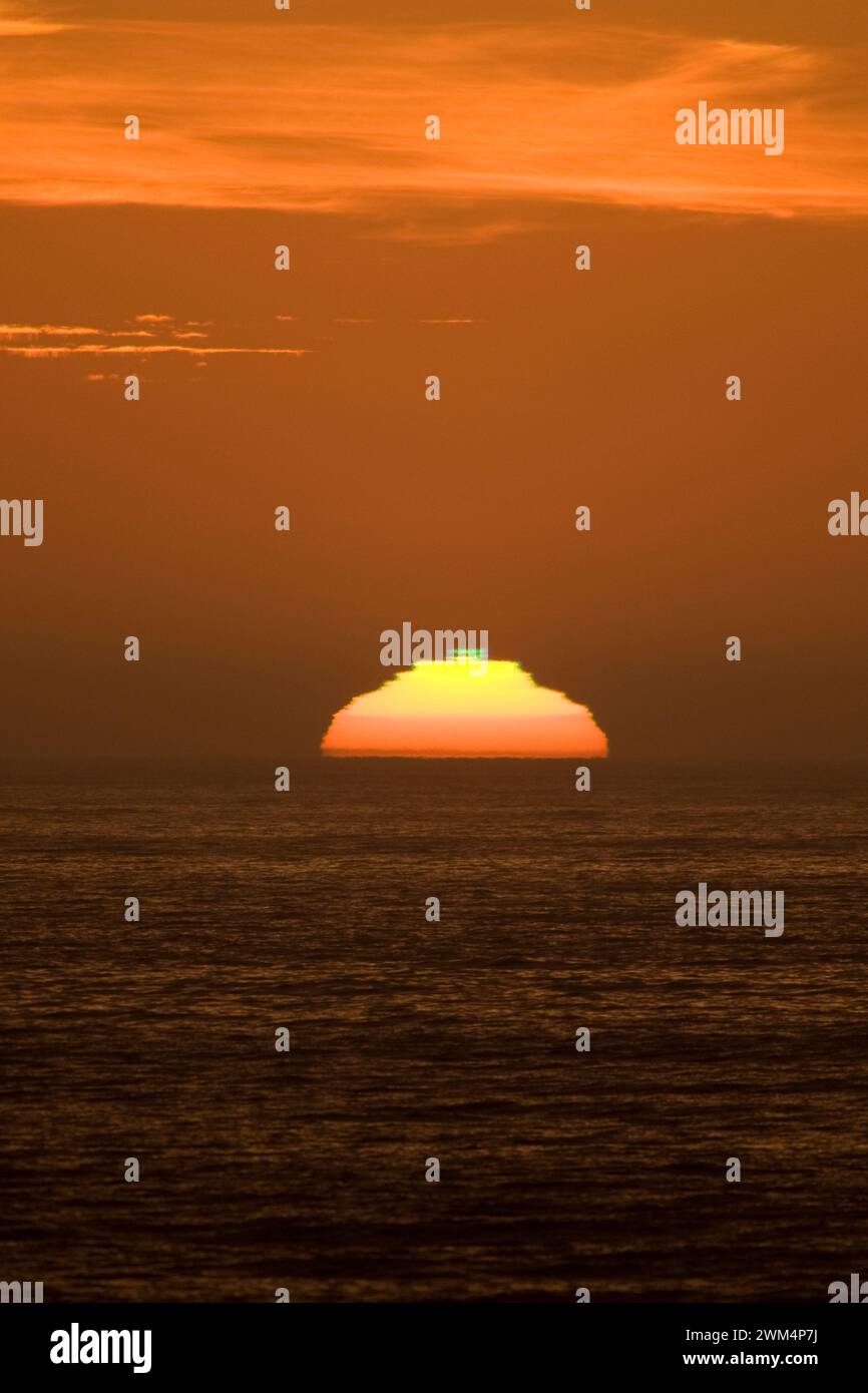 Sunsetting green flash with clouds from the eastern horizon as seen ...