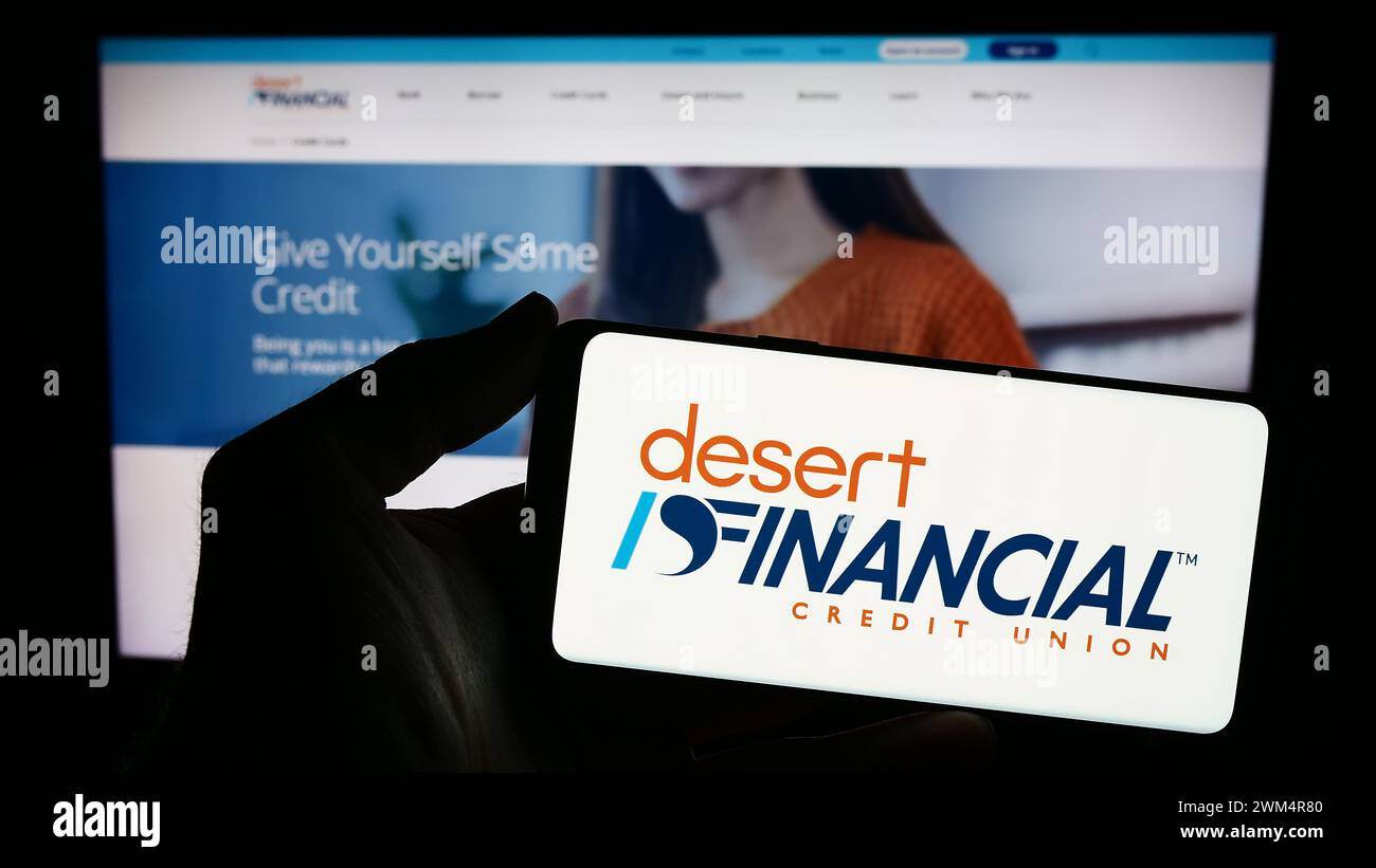 Person holding smartphone with logo of US financial services company ...