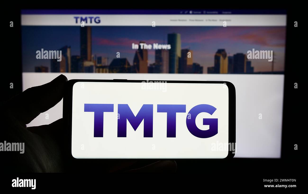 Person holding smartphone with logo of US company Trump Media ...