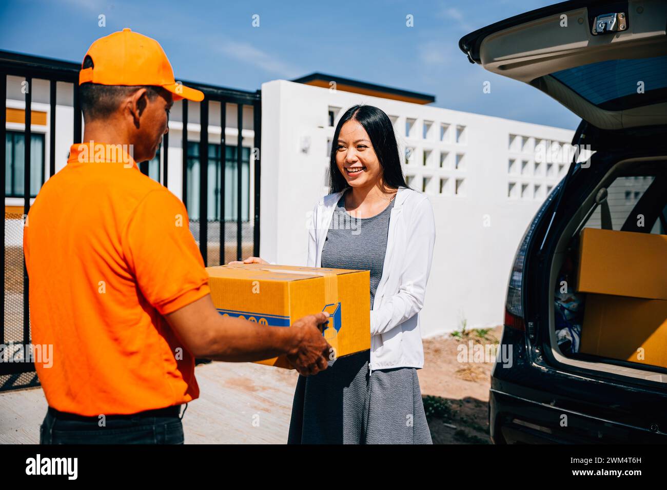 Efficient home delivery logistics depicted as a courier delivers a ...