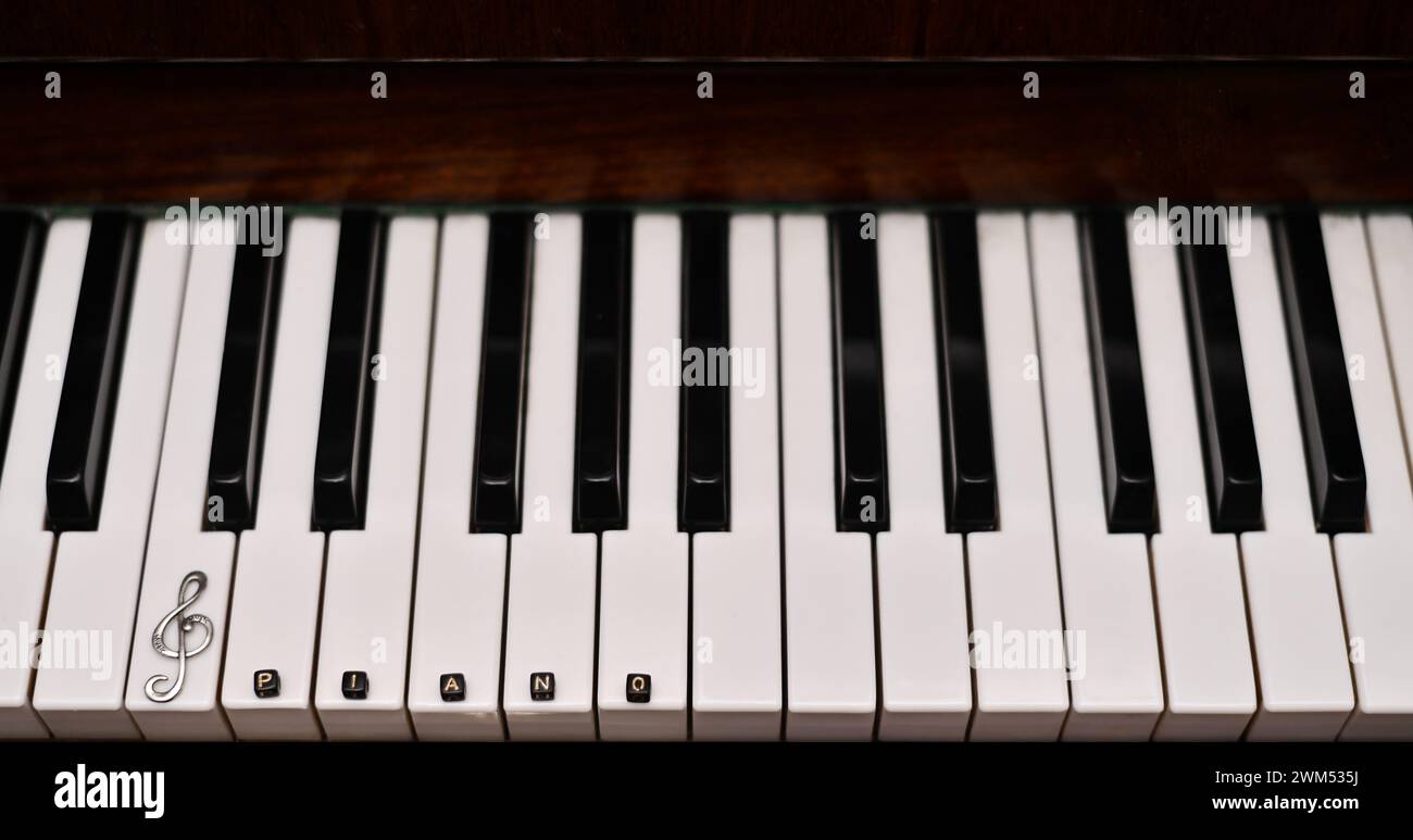Treble clef on the piano keyboard. the inscription of the piano Stock ...