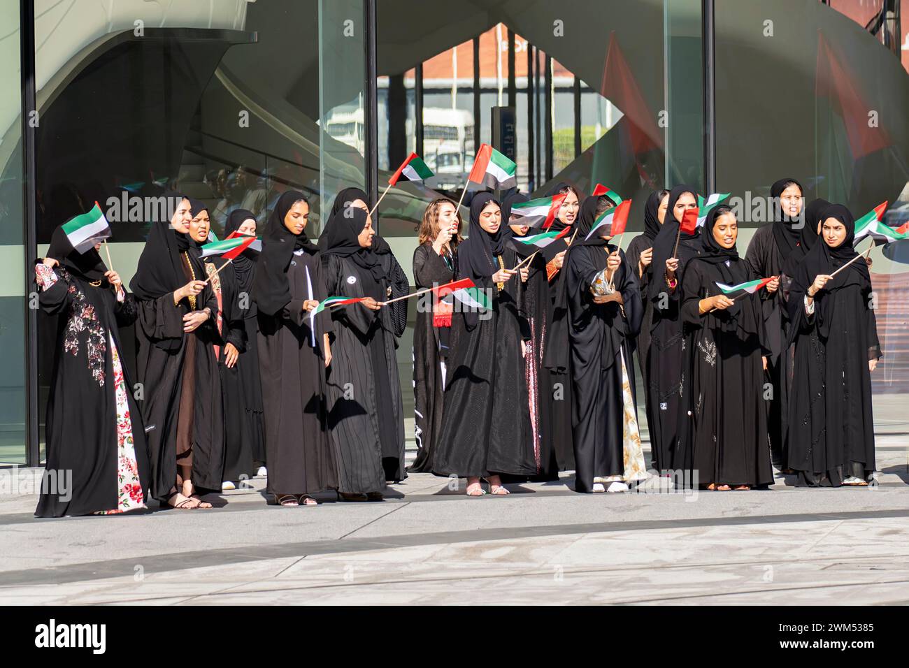 Dubai, UAE - November 28, 2022: womens in traditional clothes wave ... Dubai, UAE - November 28, 2022: womens in traditional clothes wave ...
