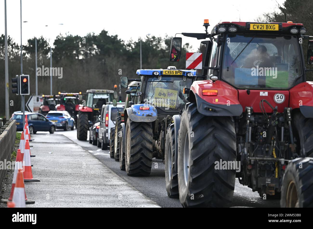 Farmers take part in a drive-slow protest in their tractors and farm ...