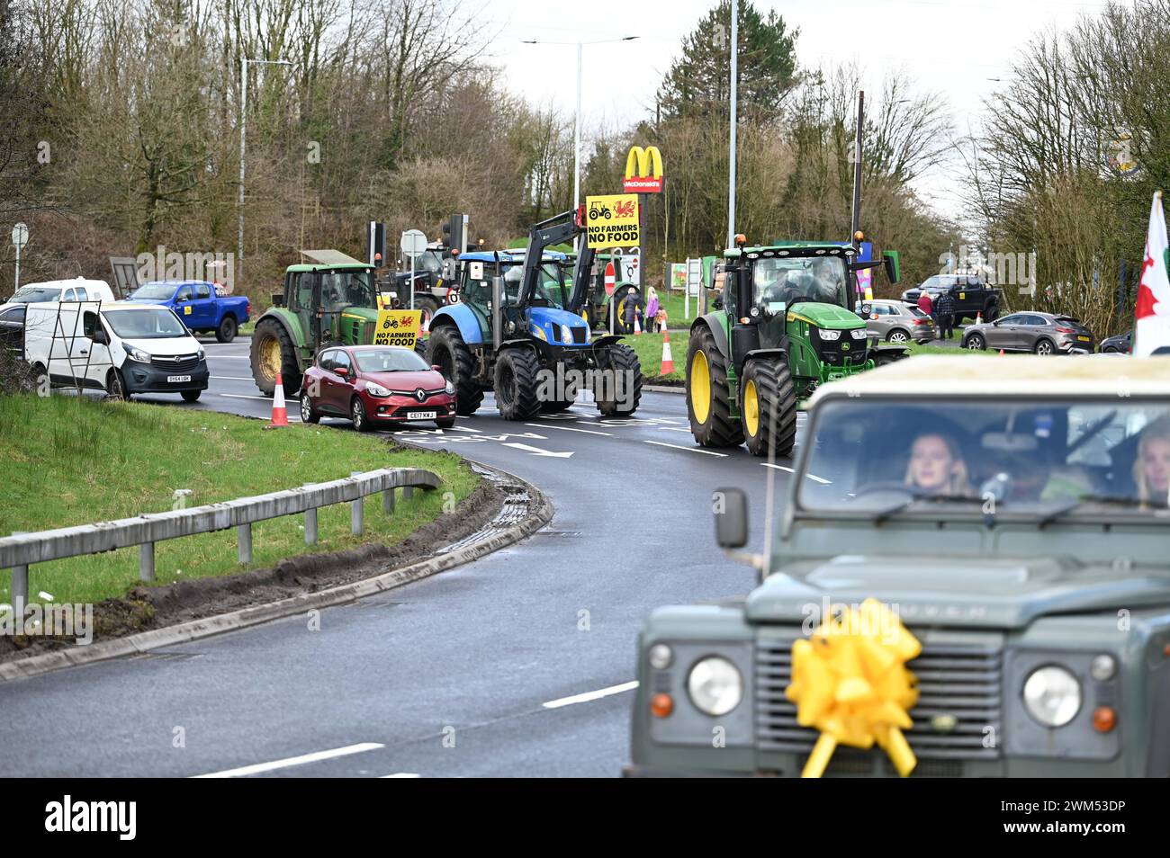 Farmers take part in a drive-slow protest in their tractors and farm ...