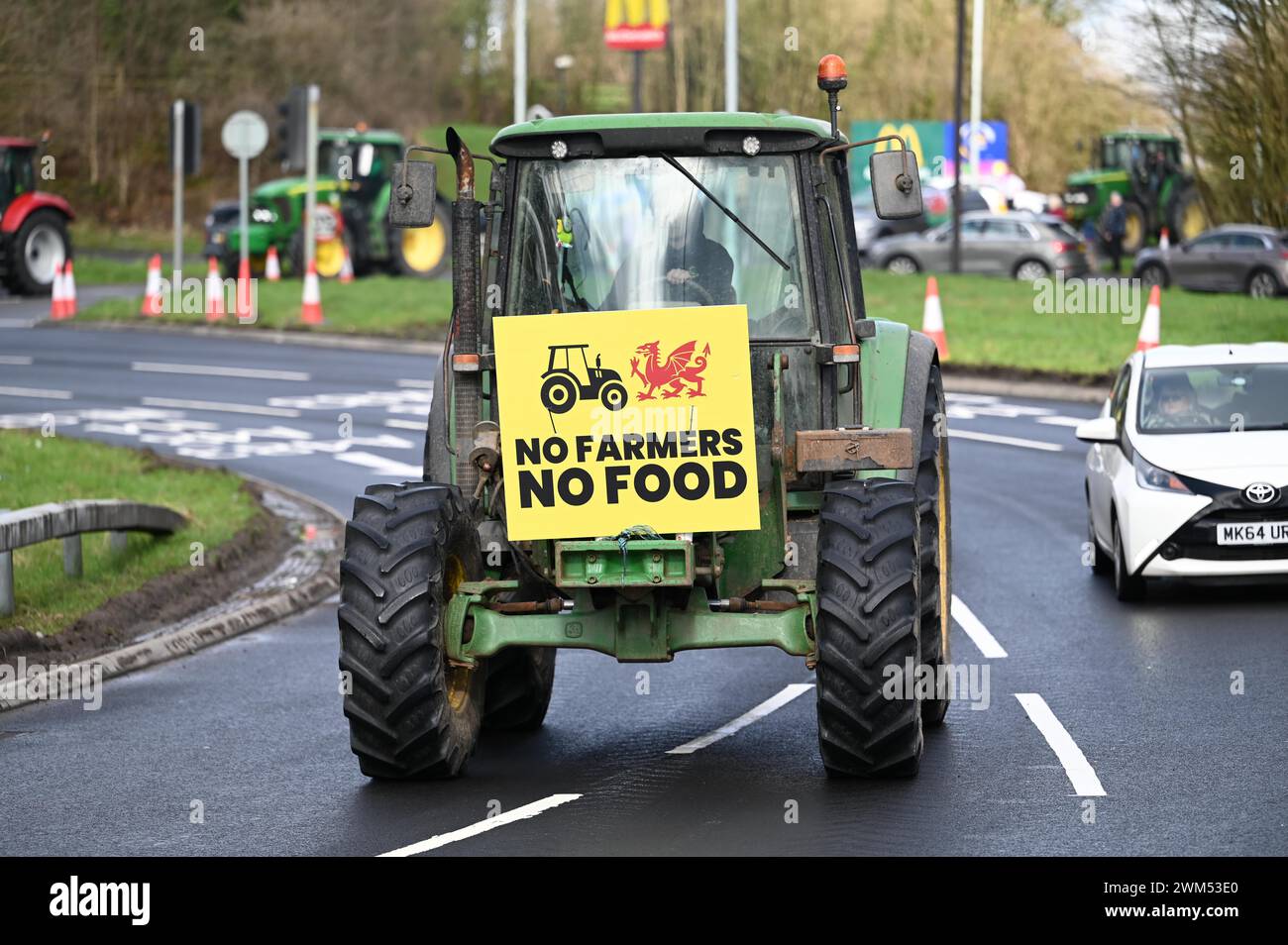 Farmers take part in a drive-slow protest in their tractors and farm ...