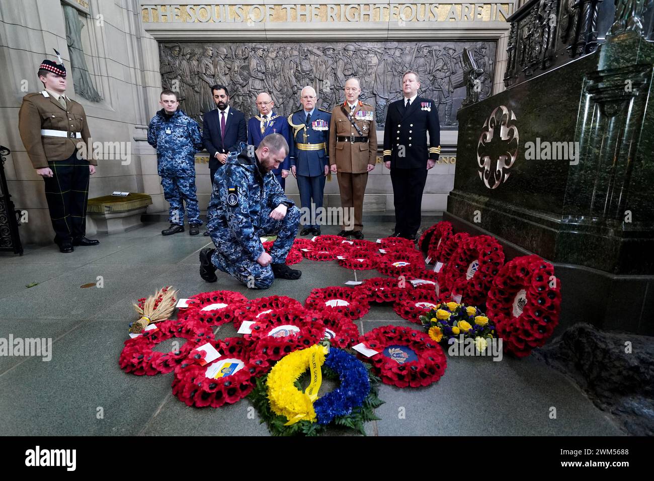 Lt CDR Ivan Dolhykh alongside wreaths laid during a service to mark the ...