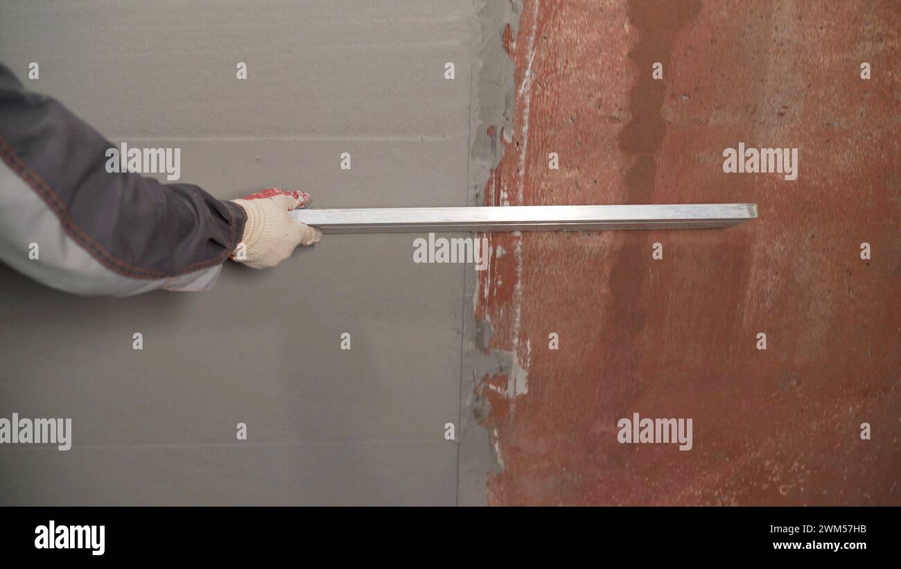 Worker plasters wall spatula hi-res stock photography and images - Alamy