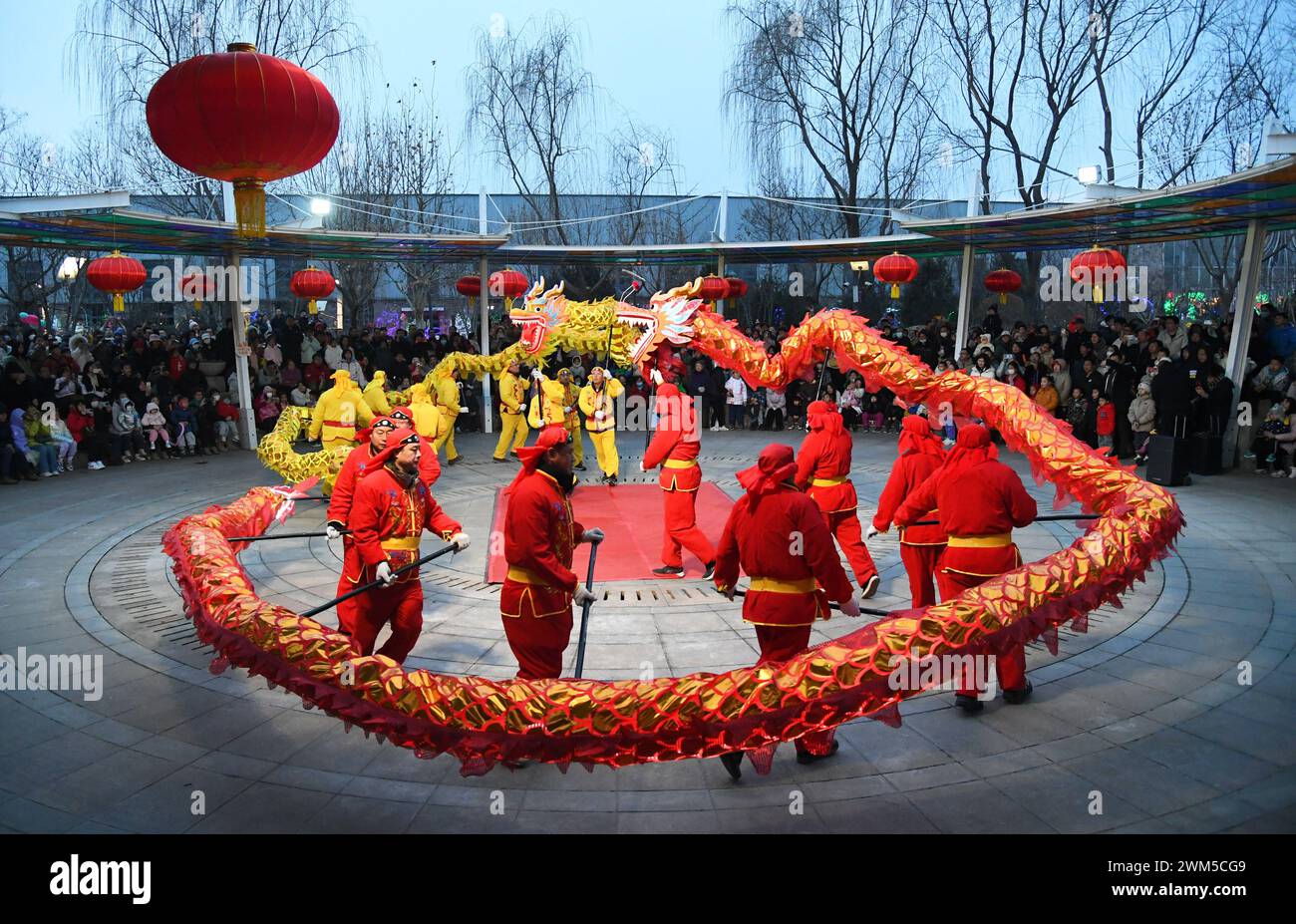 Beijing, China. 24th Feb, 2024. Tourists watch dragon dance at Nangong ...