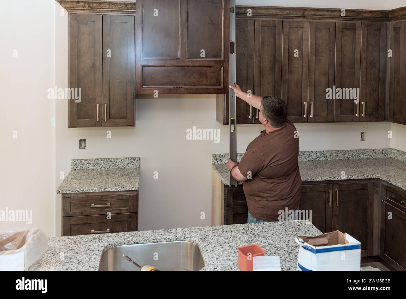 Level measurement tool is used by supervisor during assembly of new ...