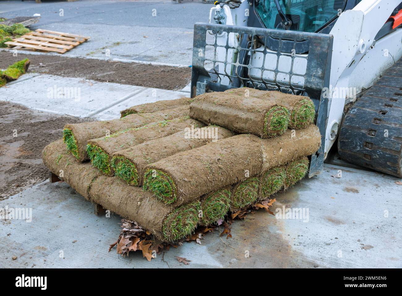 Pallet containing stacked turf grass rolls in residential landscape ...