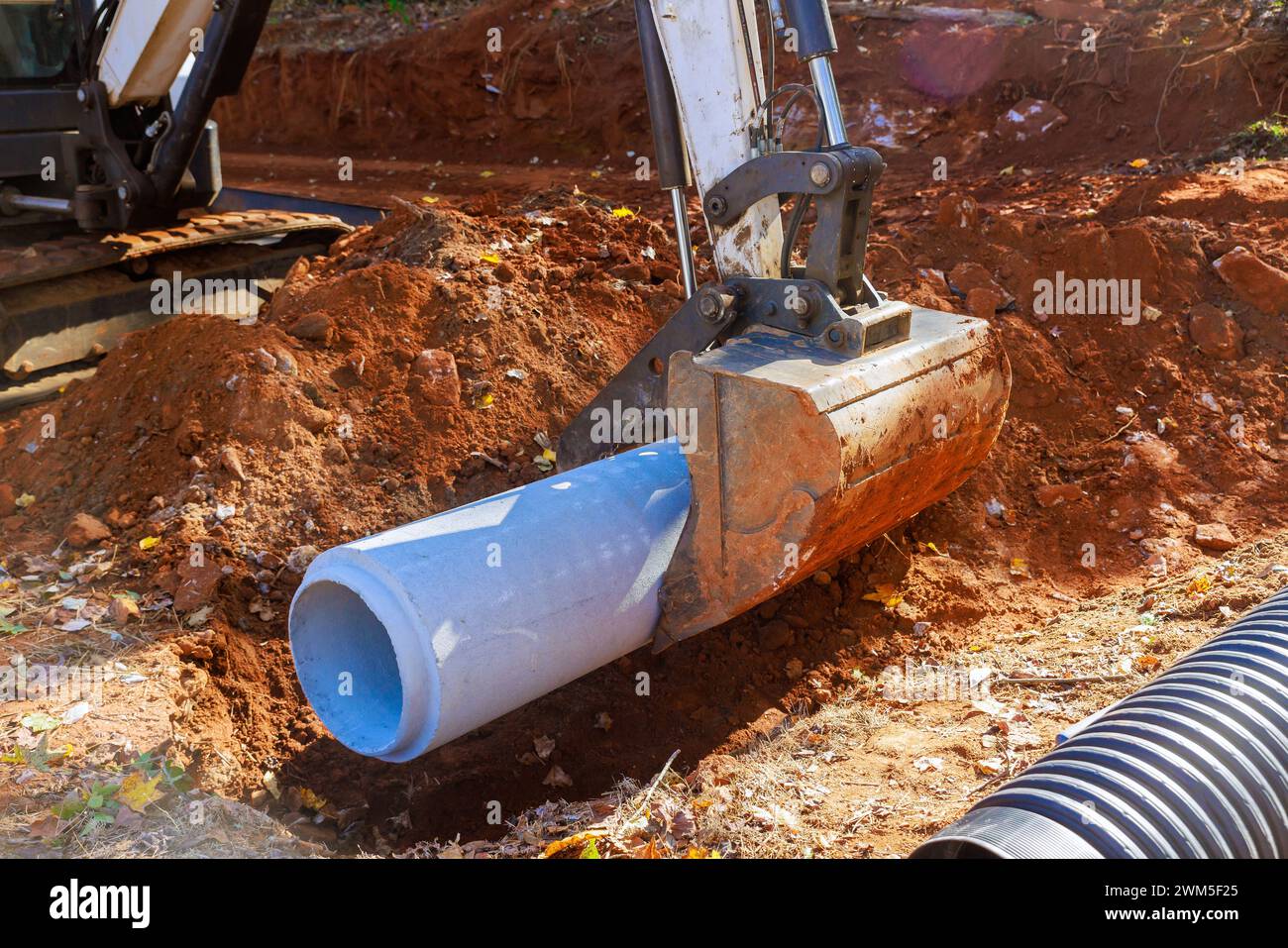 Laying pipes to feed rainwater into water main collector at ...
