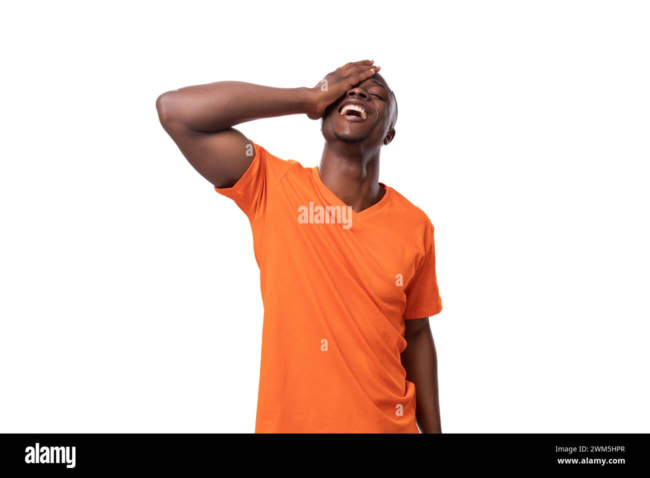 a young American guy with a short haircut dressed in an orange T-shirt ...
