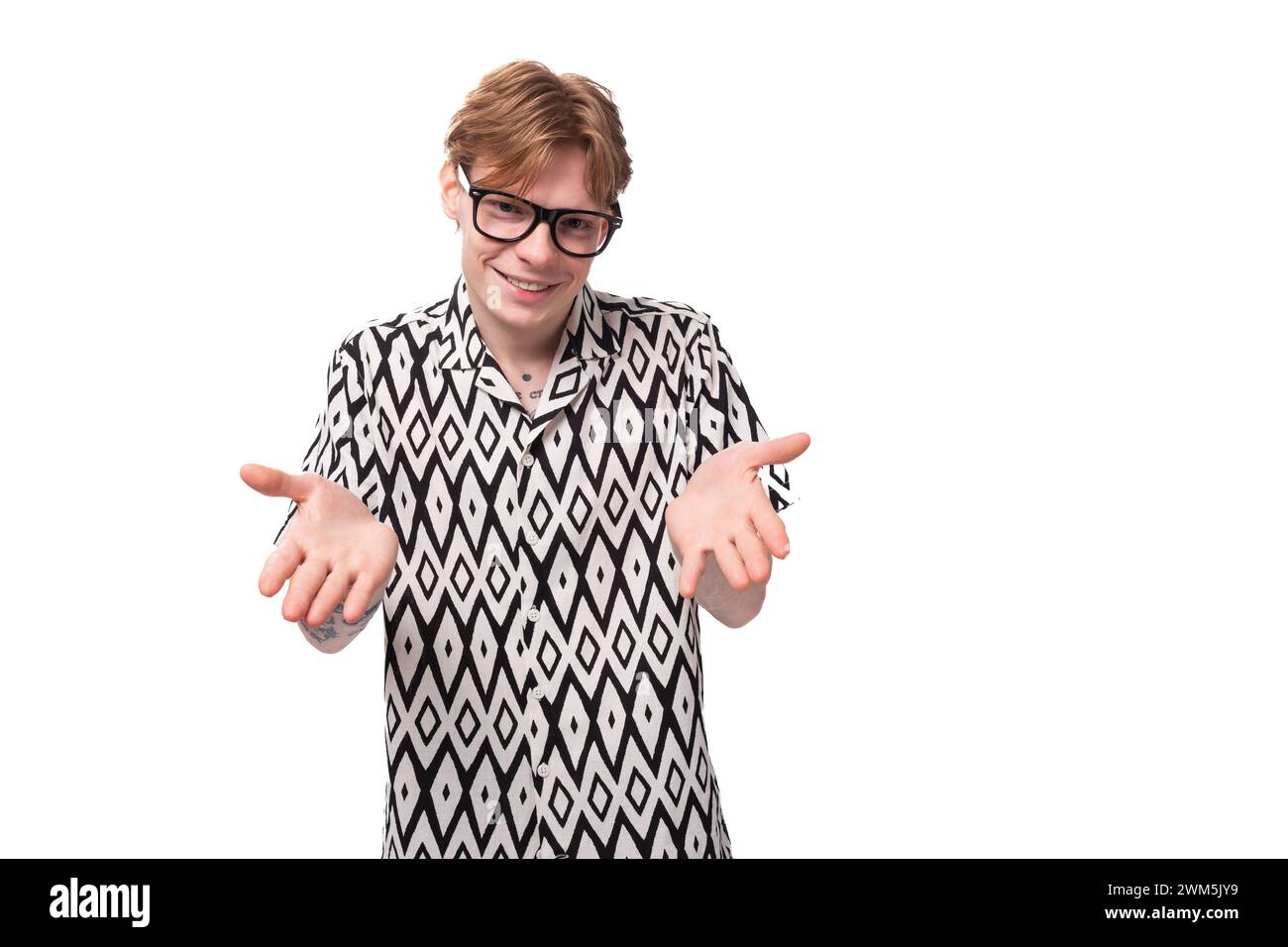 young laughing caucasian ginger man with a tattoo on his arms is ...