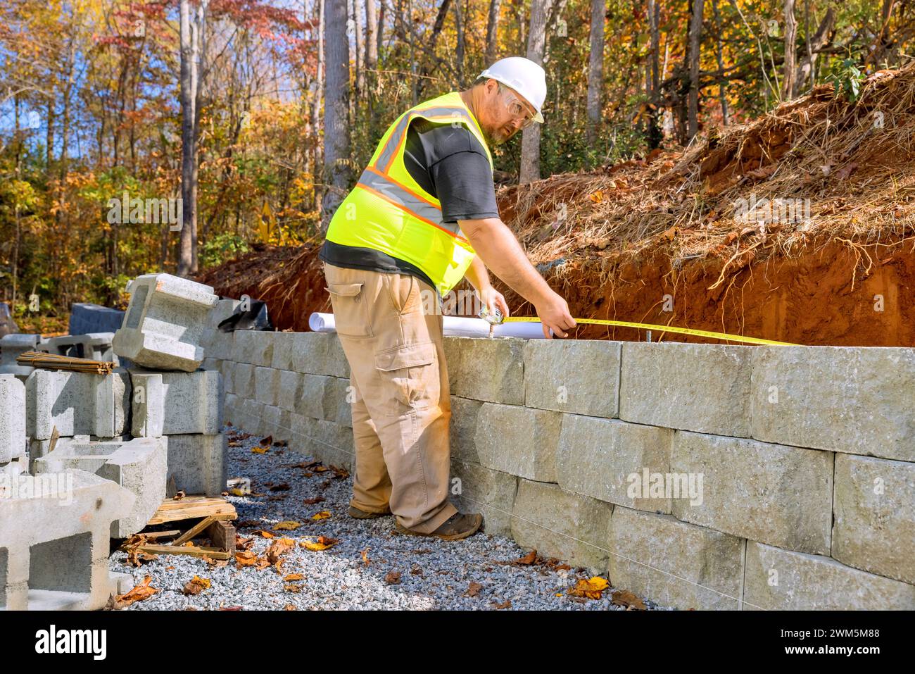 In course of mounting retaining walls by cement blocks, construction ...