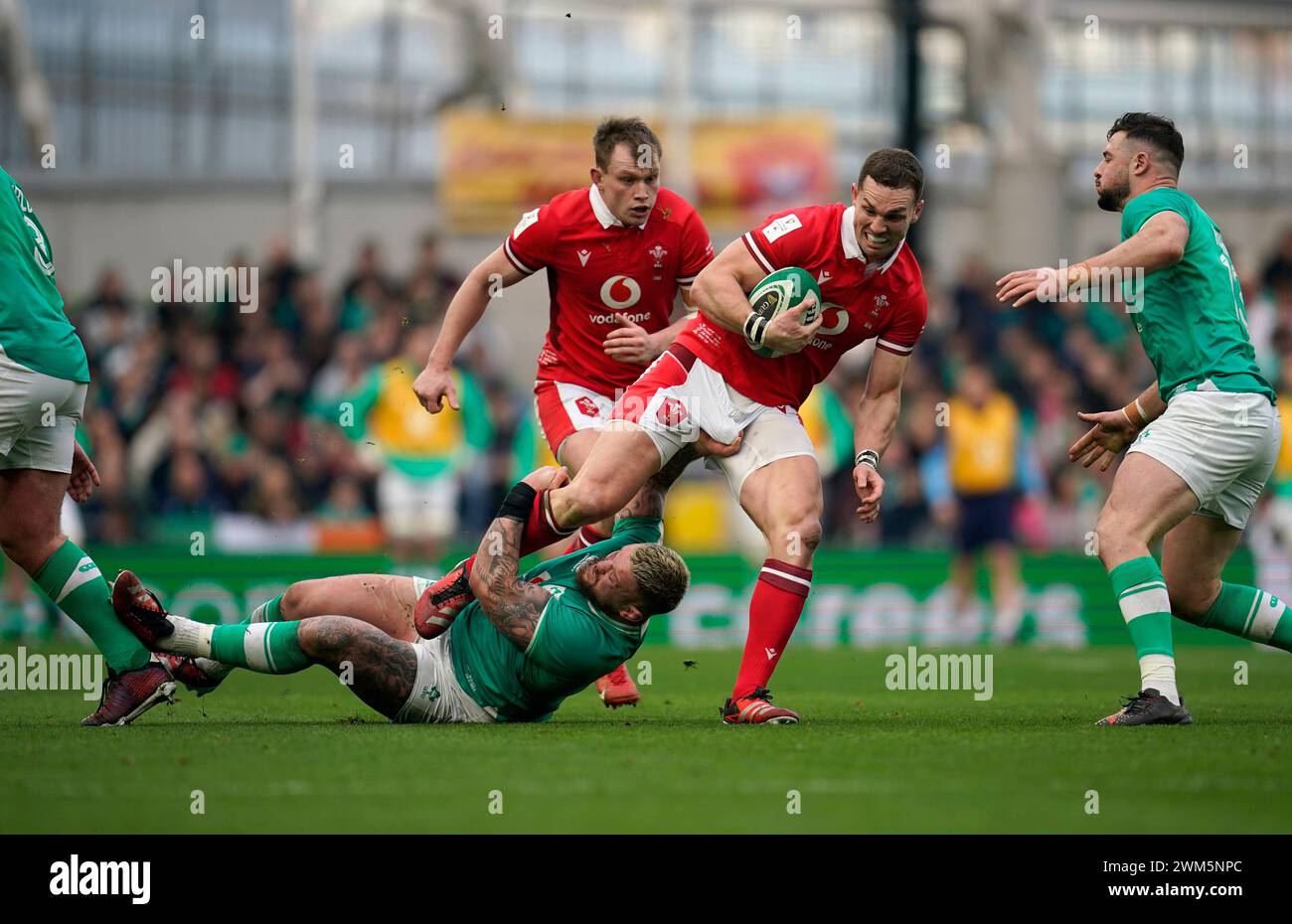 Ireland's Andrew Porter (left) tackles Wales' George North during the ...