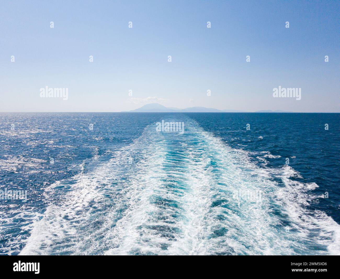 Bright sea water trail behind a cruise ship summer time. Ferry boat ...