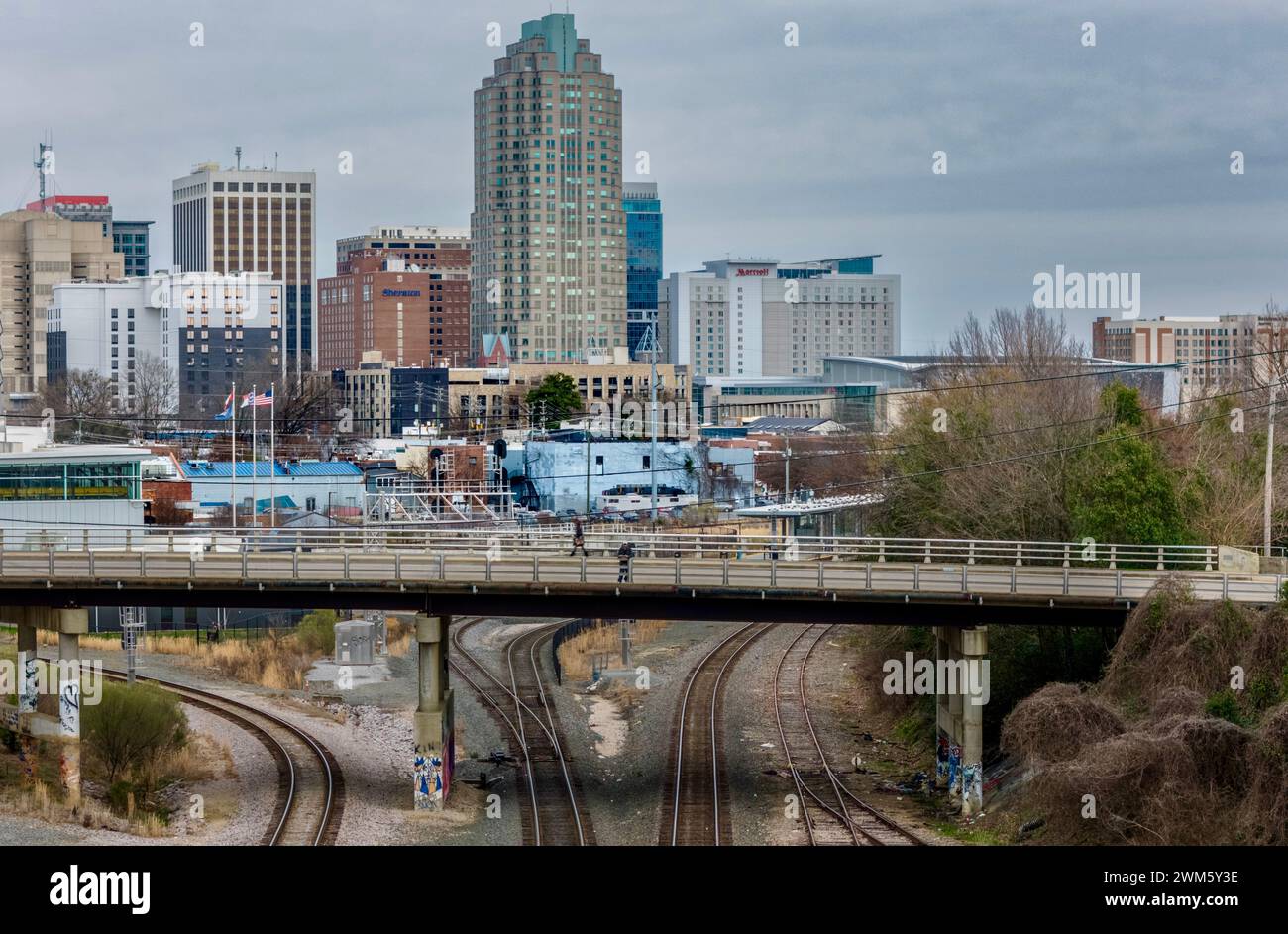 A cityscape with a bridge spanning train tracks. Boylan Bridge, Raleigh ...