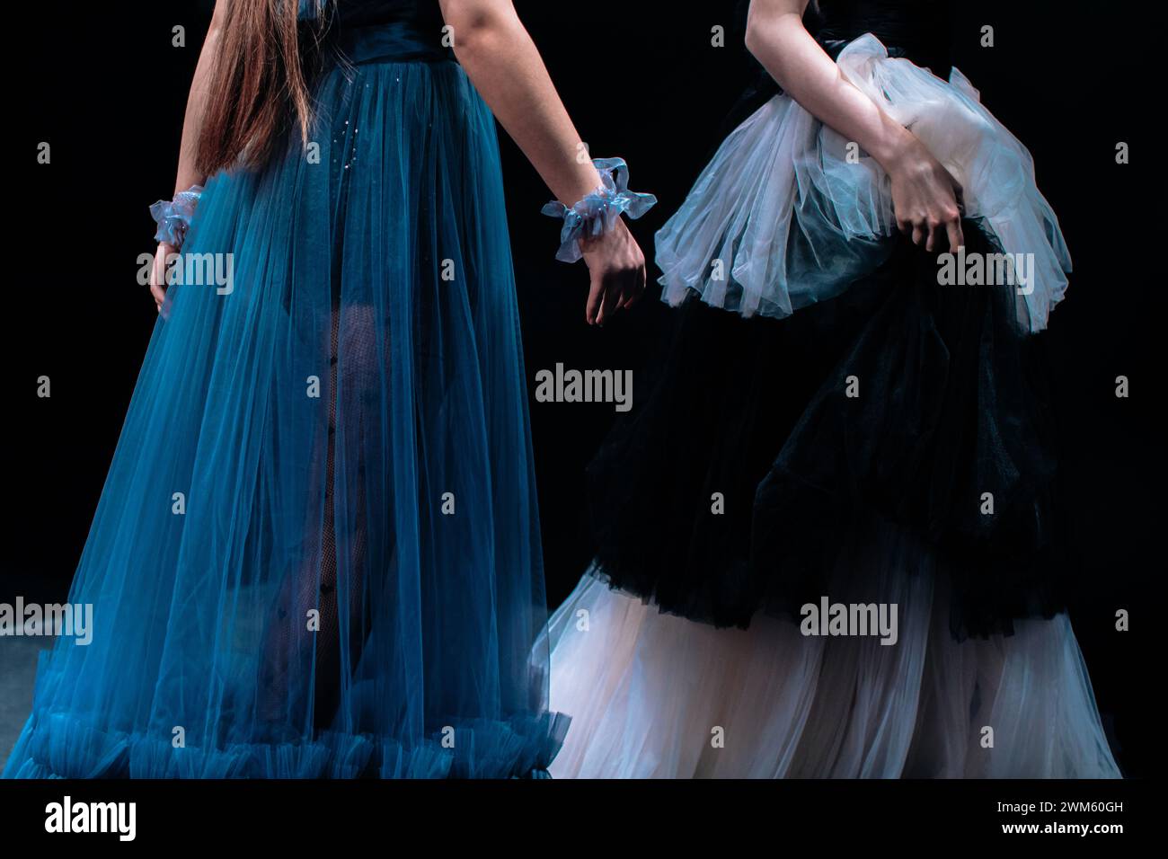 Long fluffy evening blue and white dresses on a female figures on a ...
