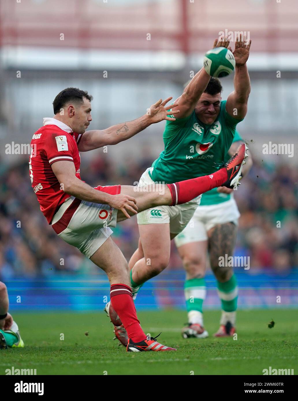 Ireland's Dan Sheehan (right) tries to block Wales' Aaron Wainwright ...